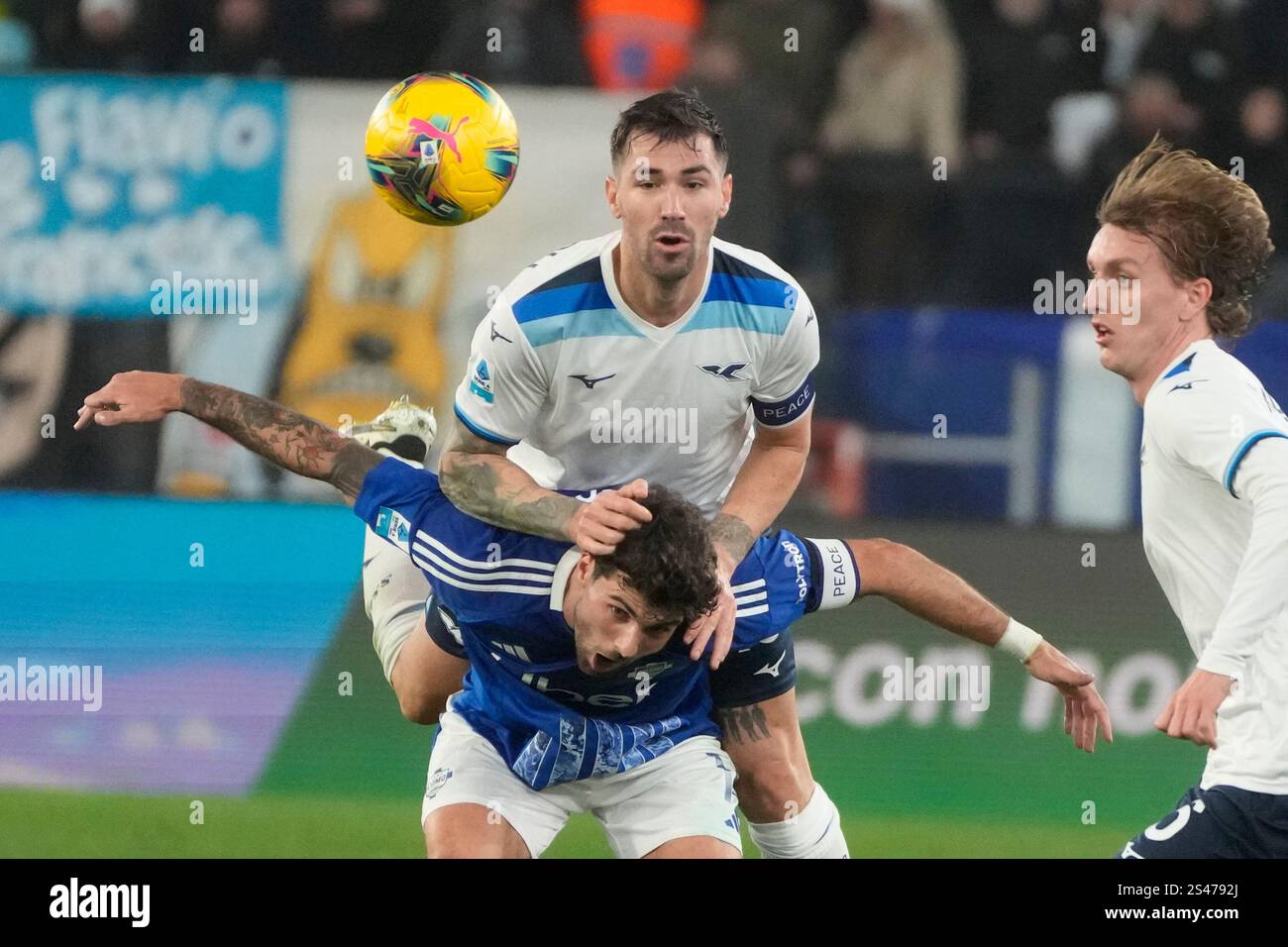 Lazio's Alessio Romagnoli, top, and Como's Patrick Cutrone challenge ...