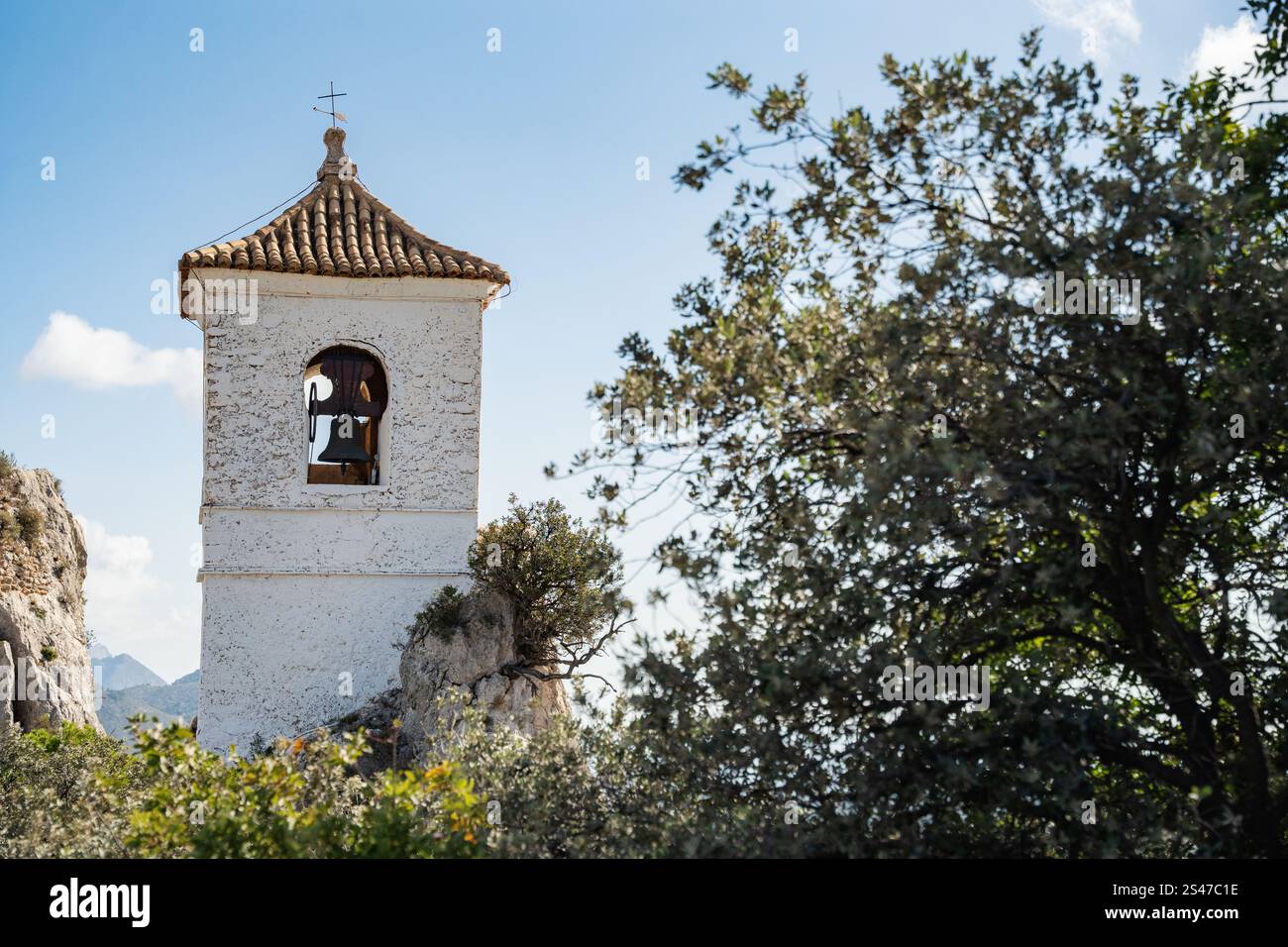 Belfry of Guadalest beautiful Spanish village, blue sky on the ...