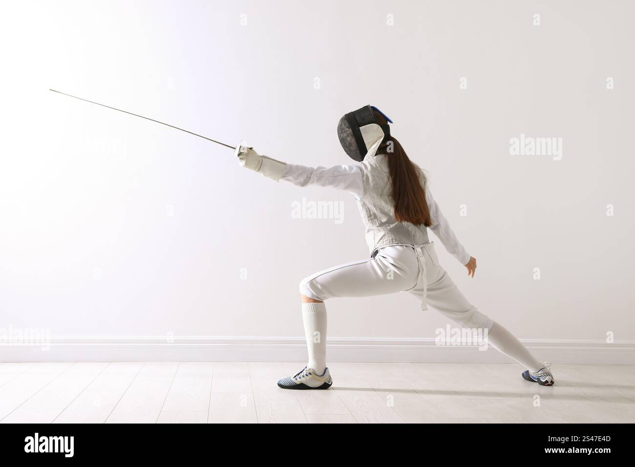Fencer with epee practicing indoors. Combat sport Stock Photo - Alamy