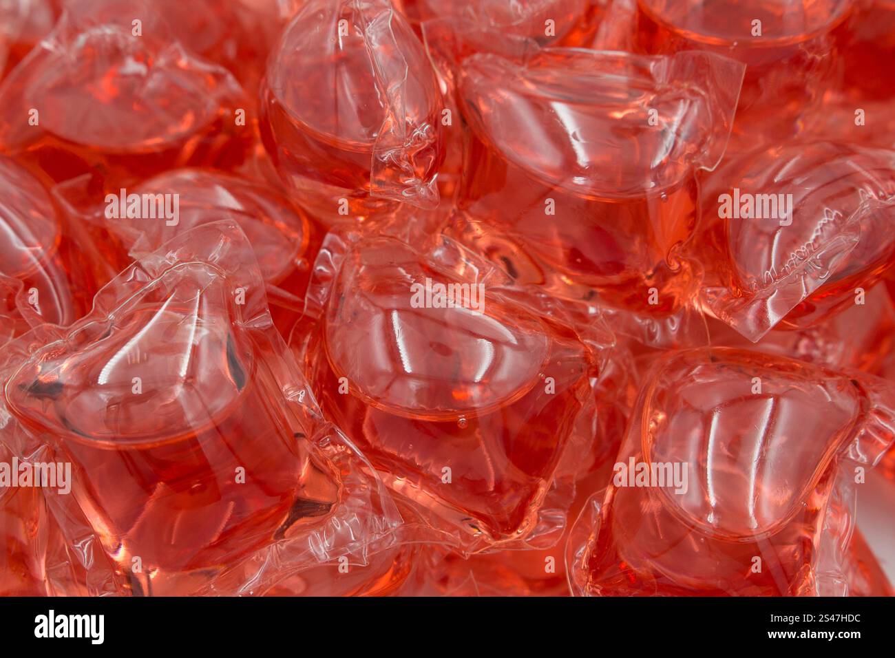 Red Gel capsules with laundry detergent close up, background Stock ...