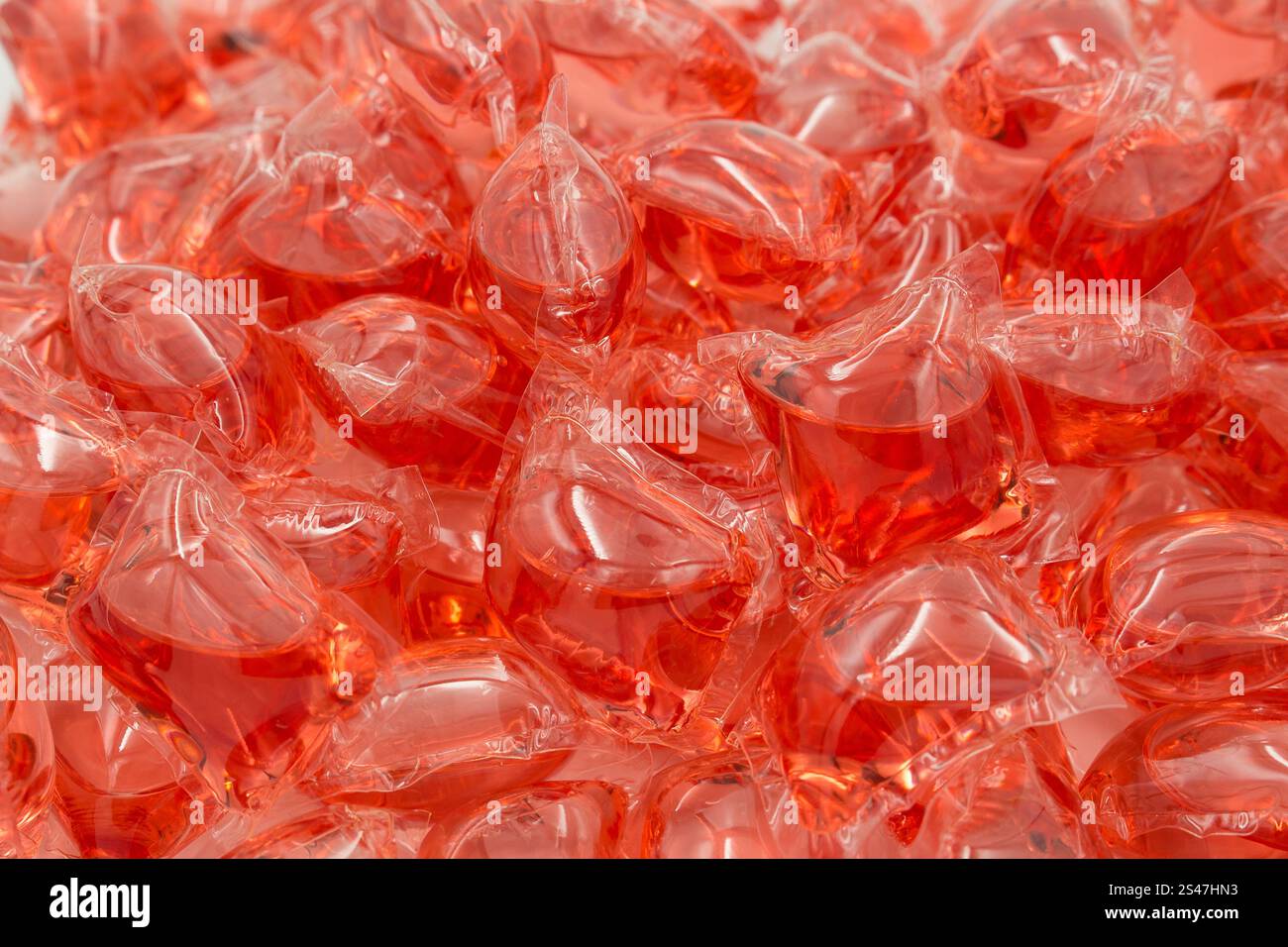 Red Gel capsules with laundry detergent close up, background Stock ...