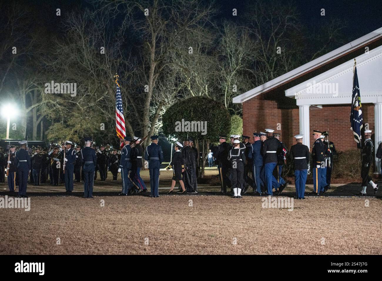 United States service members and color guard carrying the casket of ...