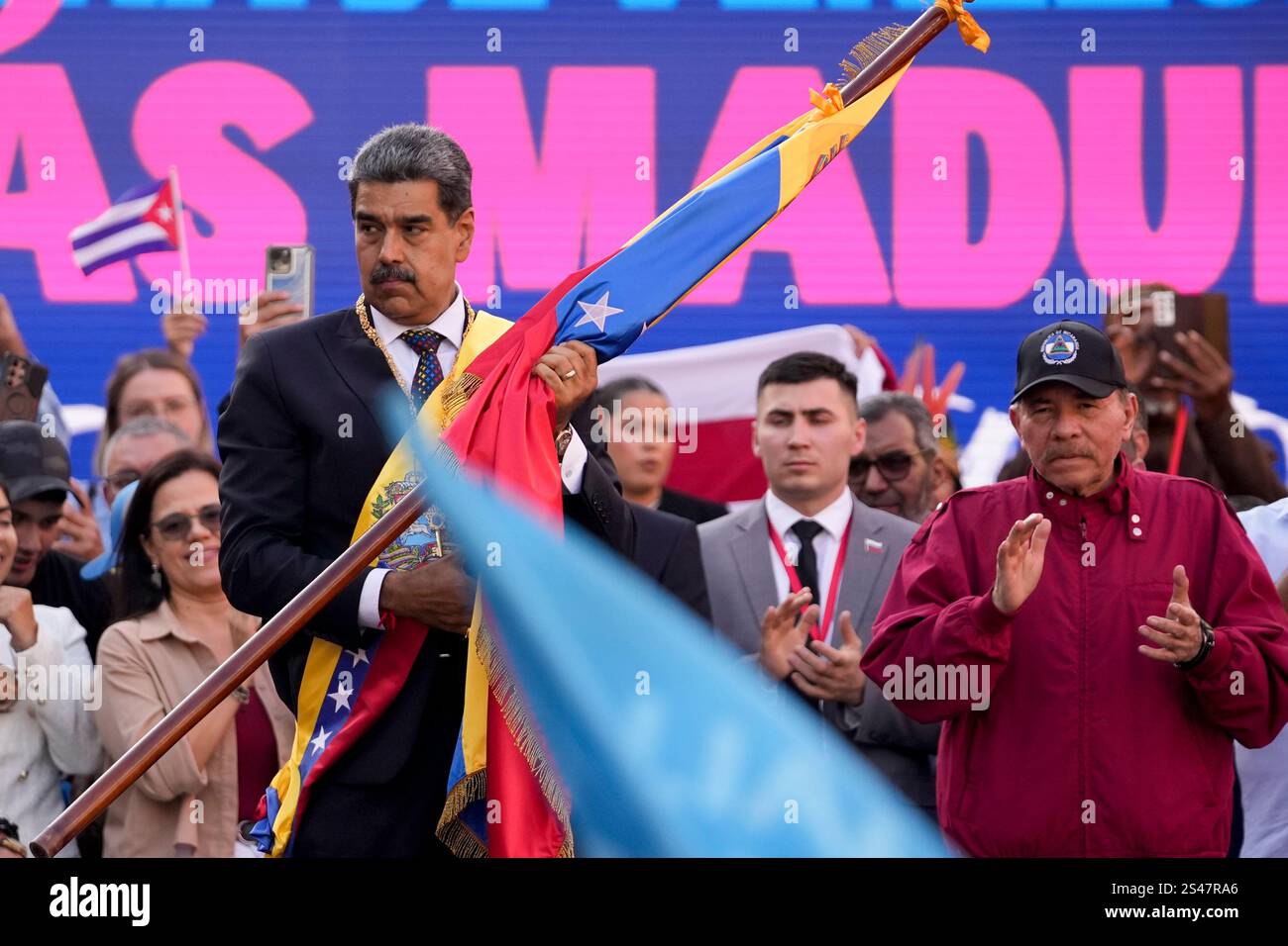 Venezuelan President Nicolas Maduro holds a national flag as Nicaragua ...