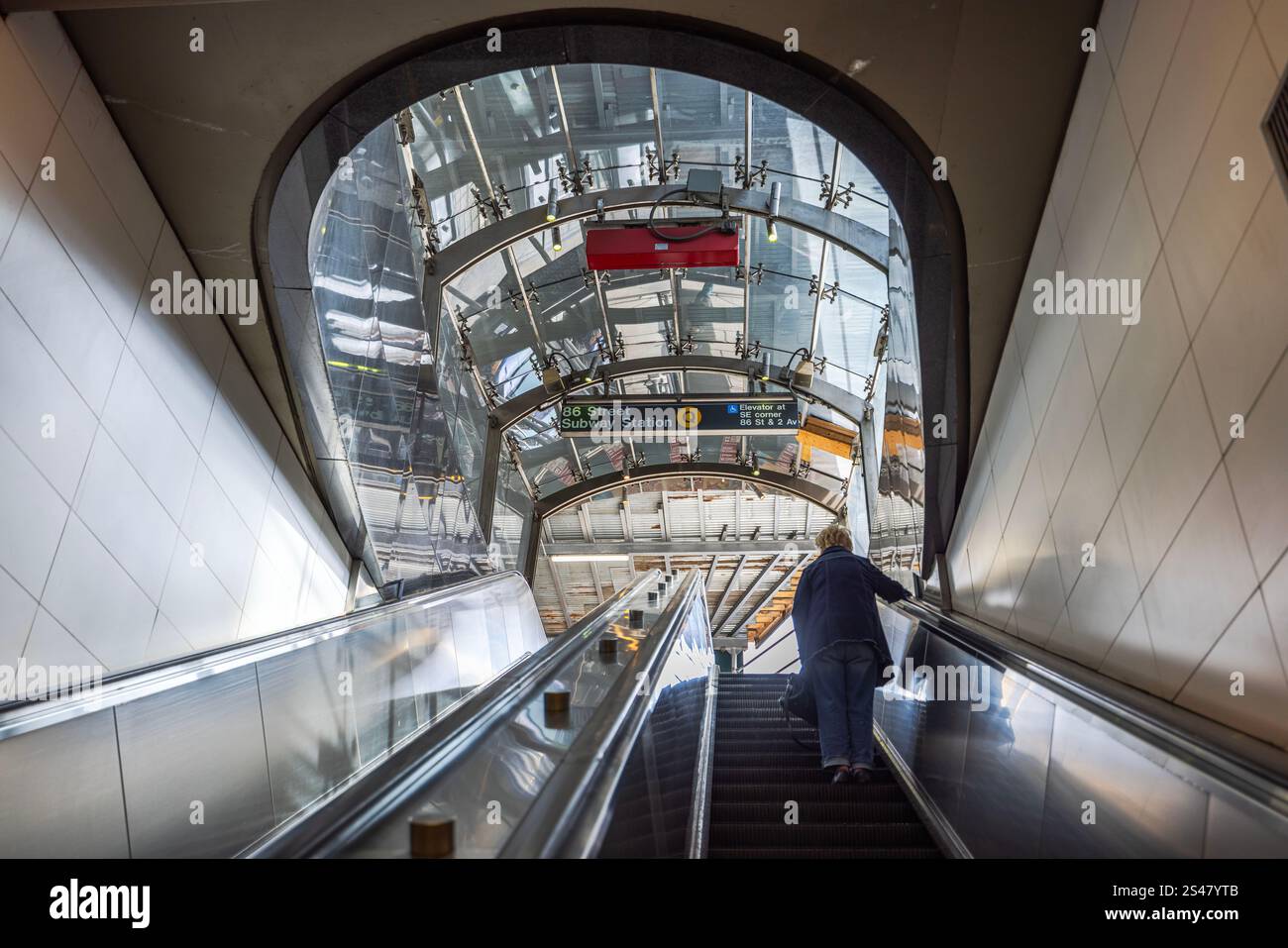 View of escalators leading to 86th Street Q subway station entrance ...