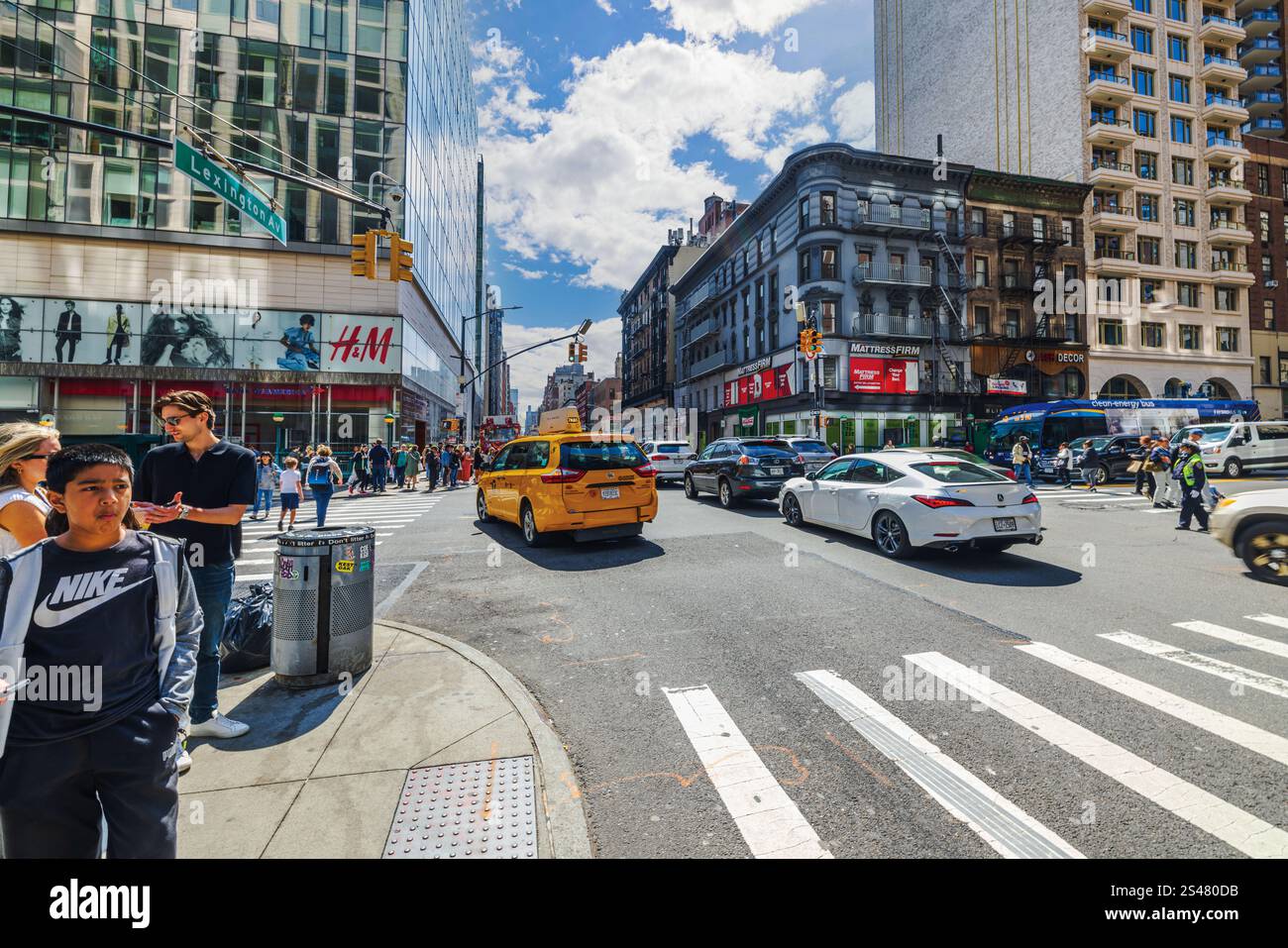 Busy urban intersection at Lexington Avenue with vibrant street life ...
