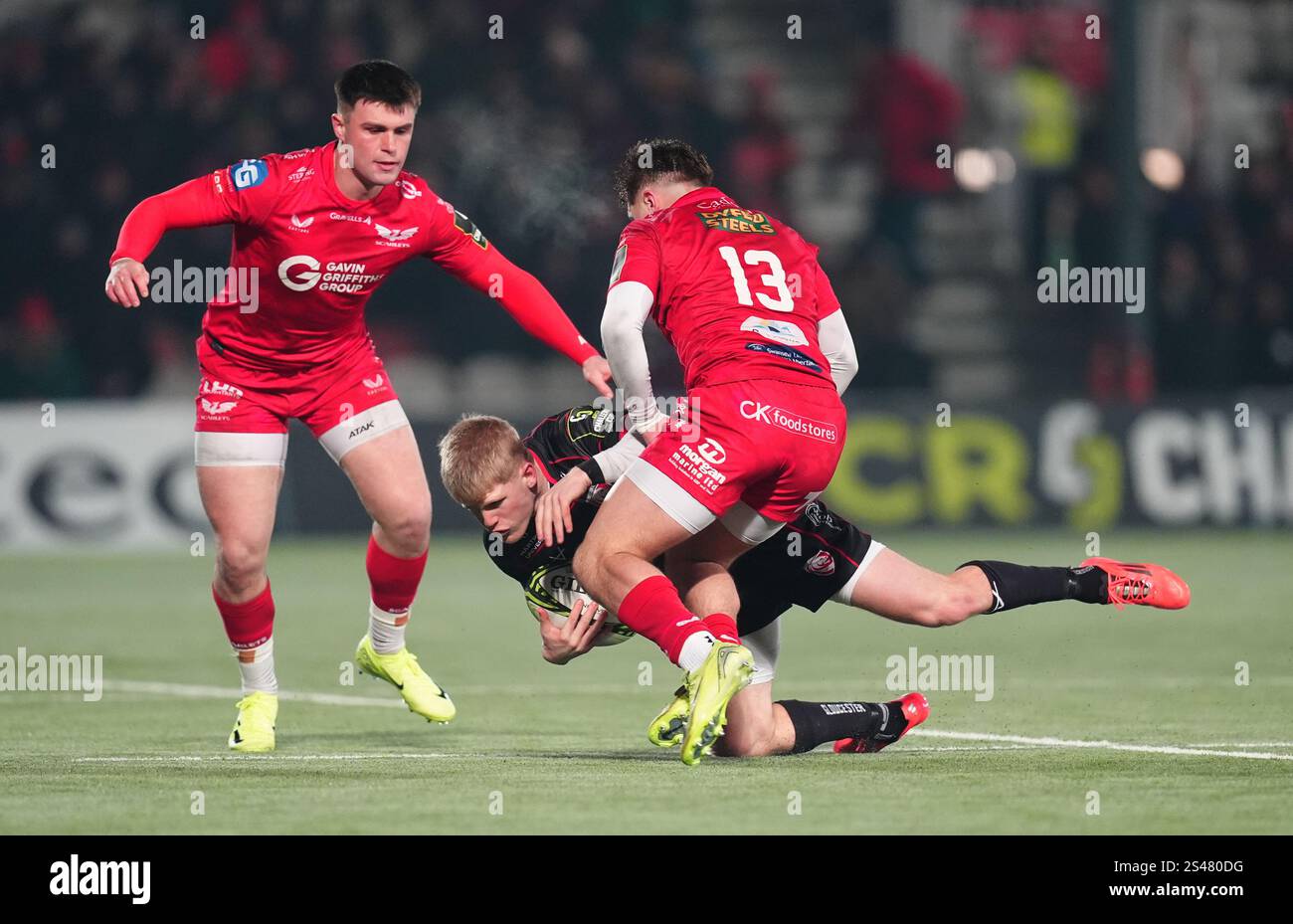Gloucester's George Barton is tackled by Scarlets' Macs Page (right ...