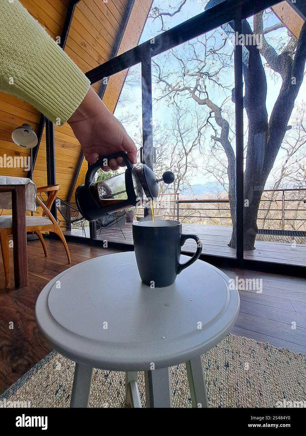 Preparing coffee in a French press or plunger coffee maker inside a ...