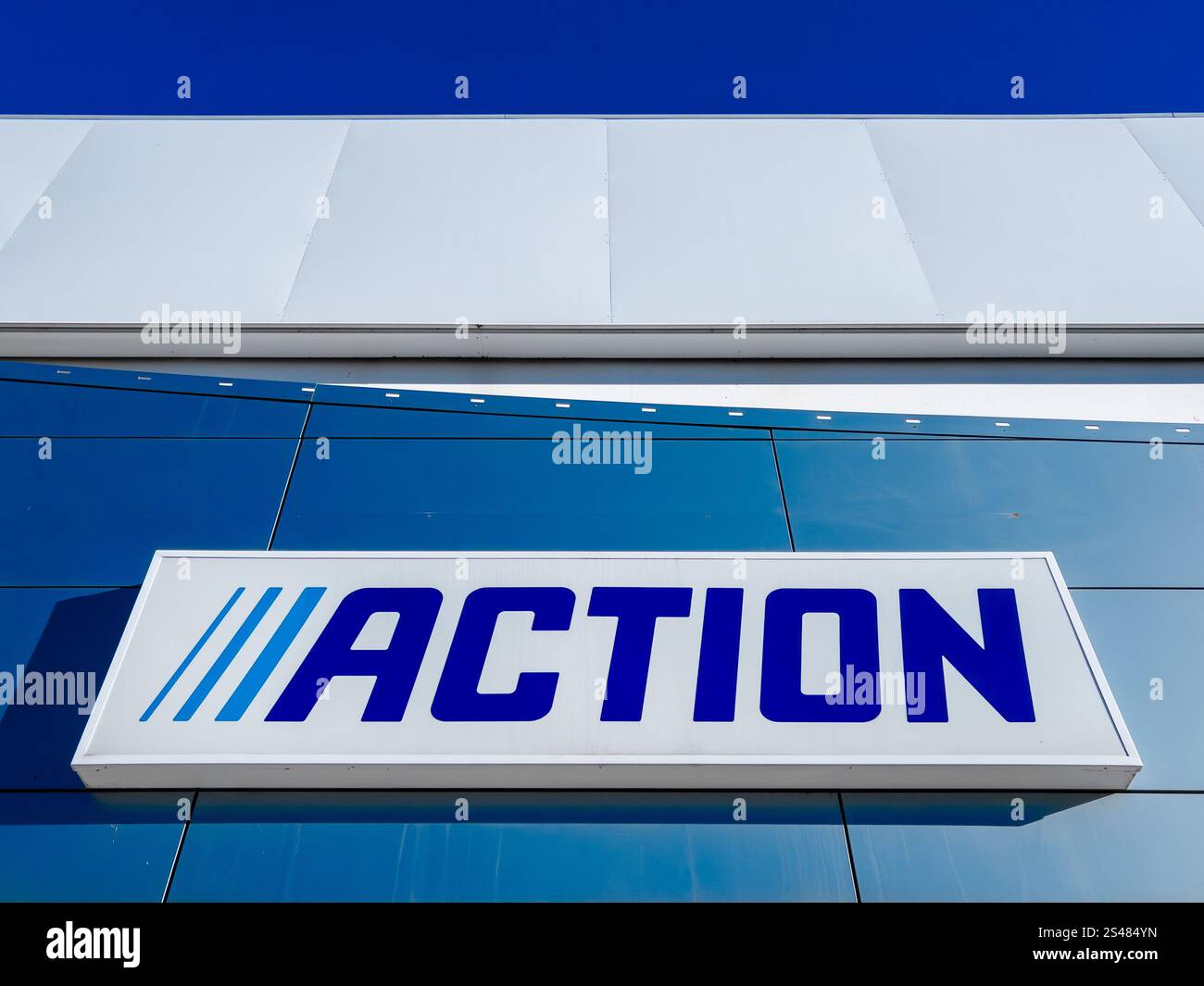 Italy - December 17, 2024: Sign of ACTION Store discount on blue sky ...