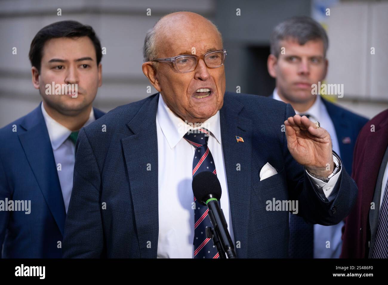 Rudy Giuliani, center, speaks to reporters after leaving federal court ...