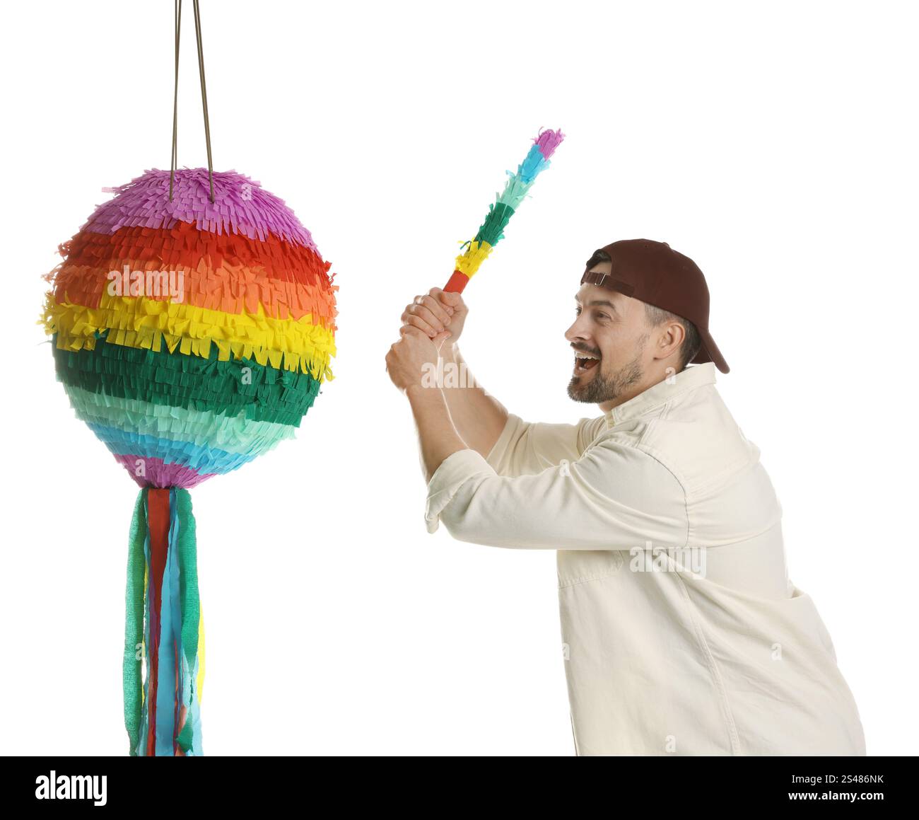 Emotional man hitting colorful pinata with stick on white background ...