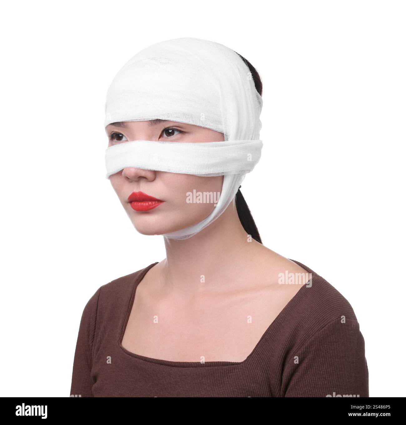 Woman with nose wrapped in medical bandage after plastic surgery ...