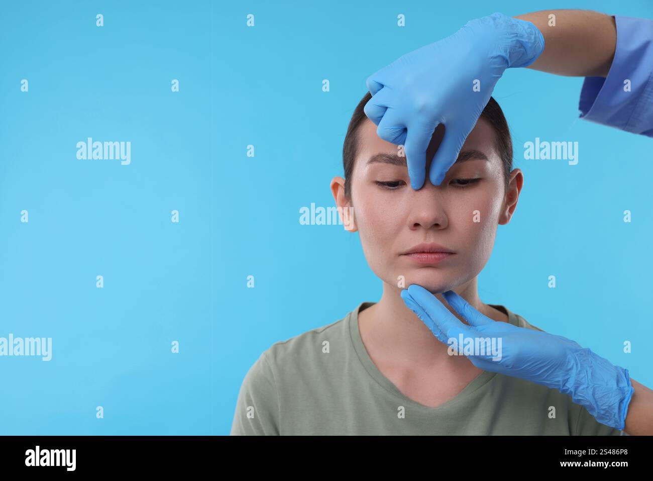 Doctor checking patient's nose before plastic surgery operation on ...