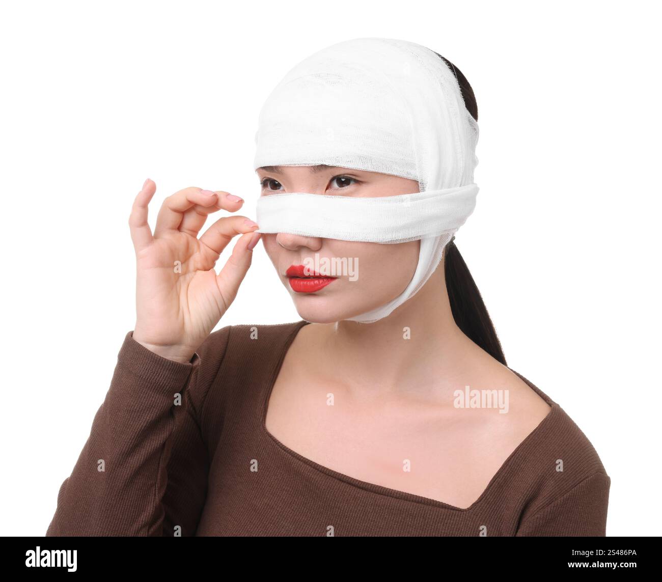 Woman with nose wrapped in medical bandage after plastic surgery ...