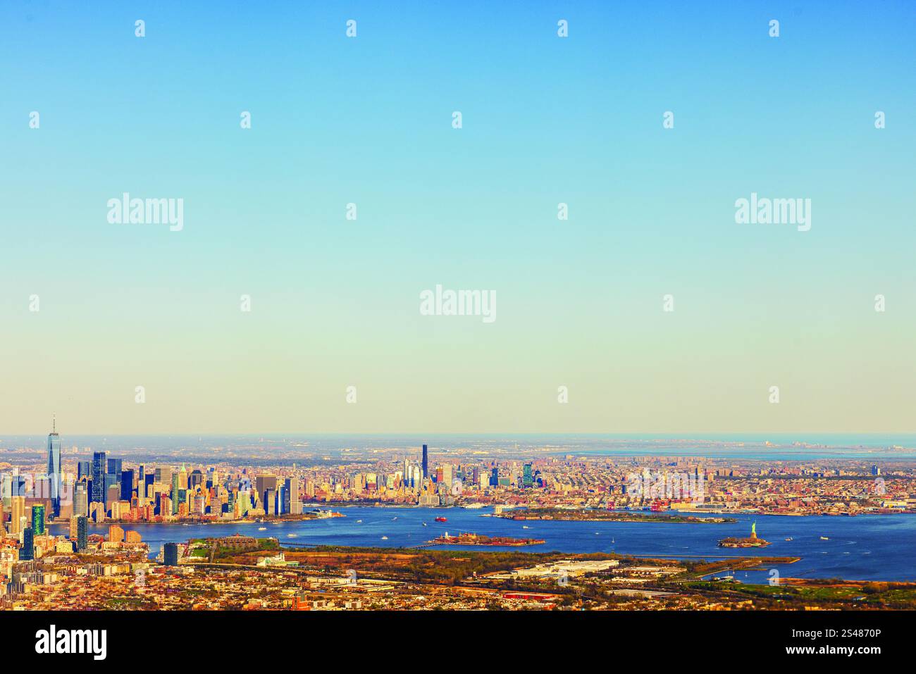 Aerial view of New York City skyline with Statue of Liberty and Upper New York Bay under clear ...