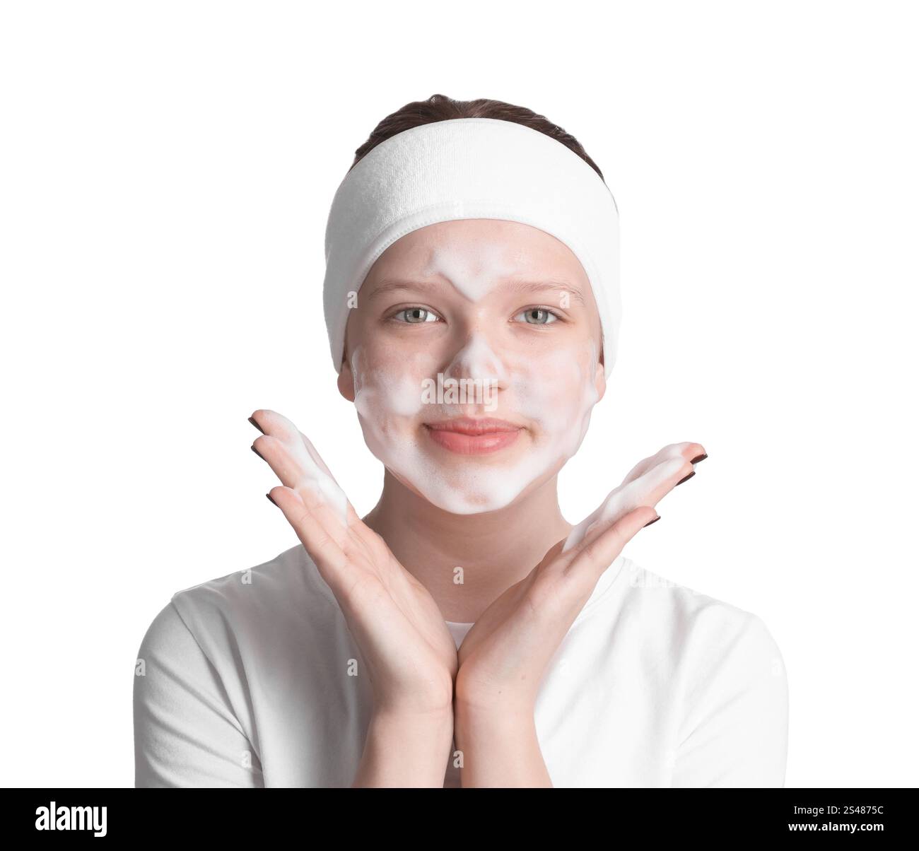 Teenage girl washing her face with cleanser on white background ...
