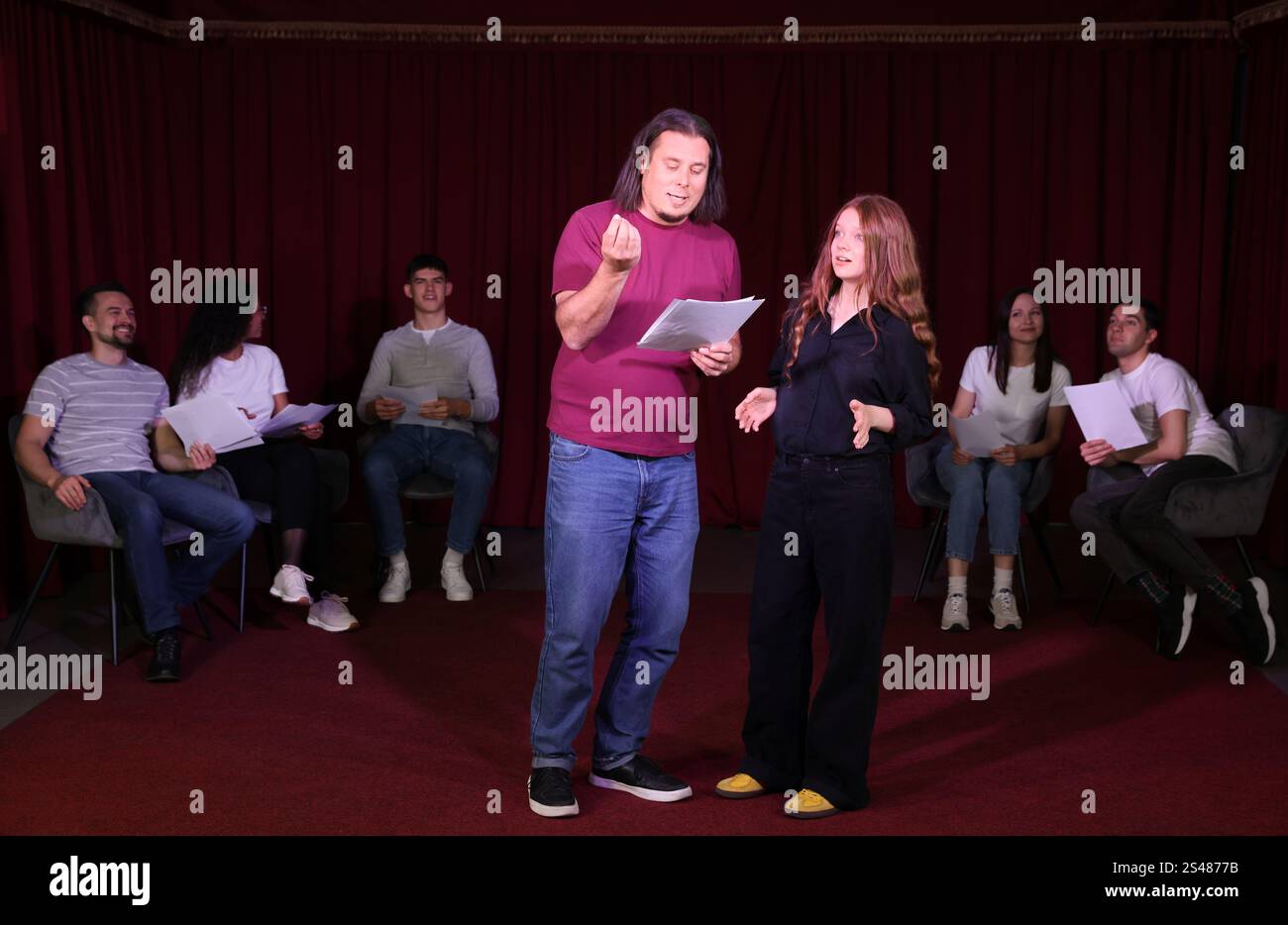 Professional actors with their scripts rehearsing in theatre Stock ...