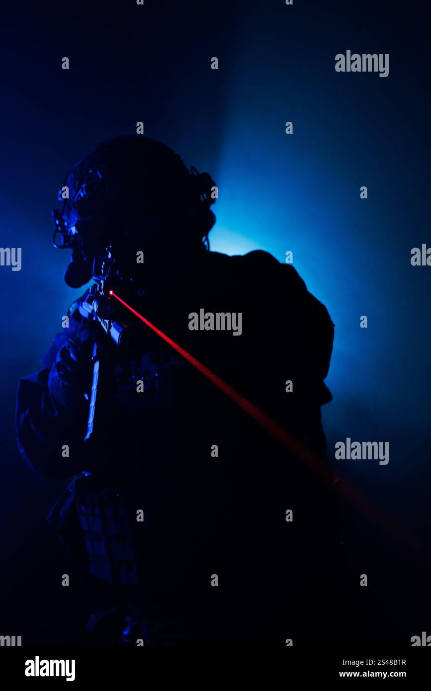 A silhouetted tactical figure holding a weapon equipped with a red ...
