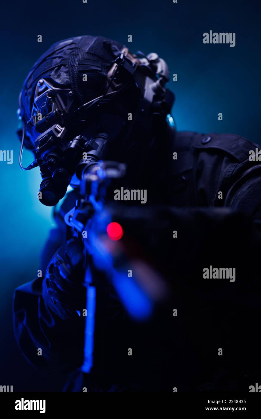 A special forces operator in tactical gear aiming a rifle in a low ...