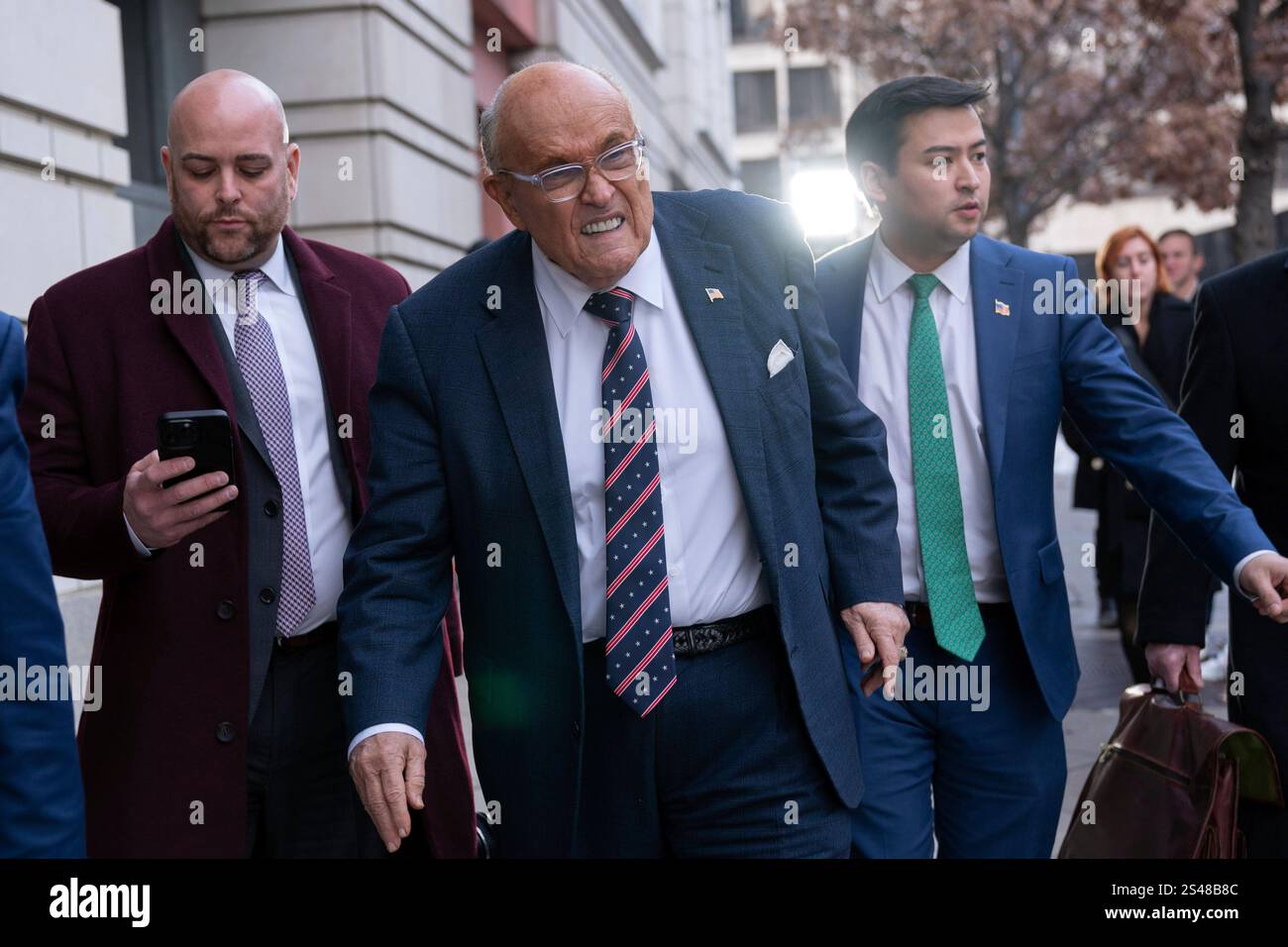 Rudy Giuliani , center, leaves federal court in Washington, Friday, Jan ...
