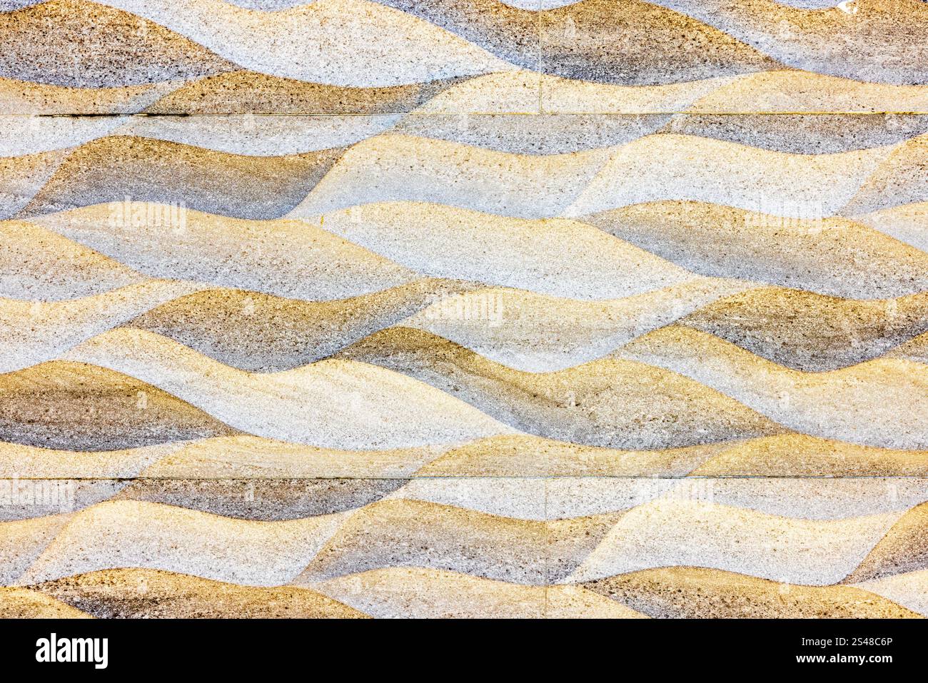 Abstract sand-colored textured wall with wave pattern design creating ...
