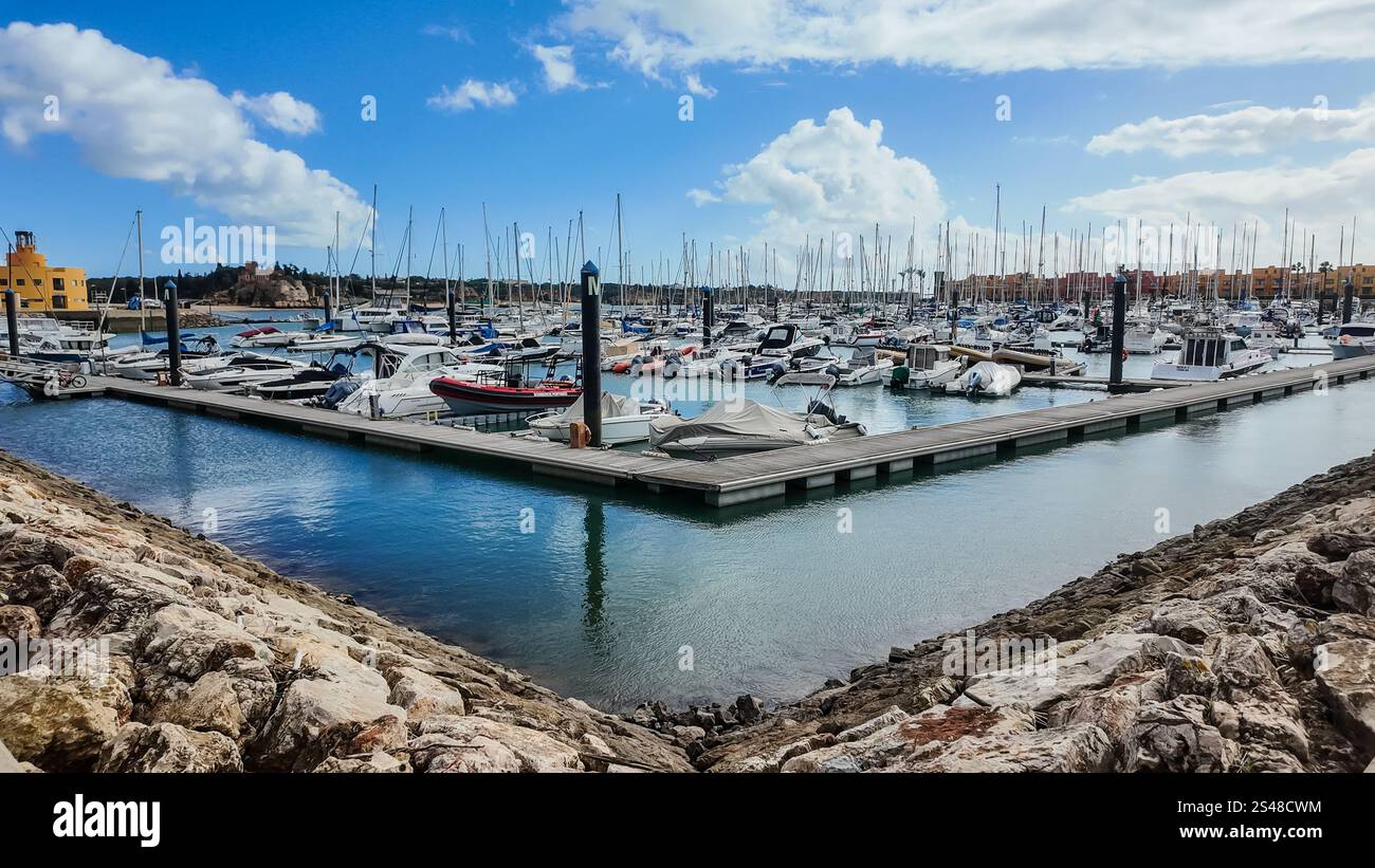 Boats docked at Portimão Marina, Portugal, under clear blue skies and ...