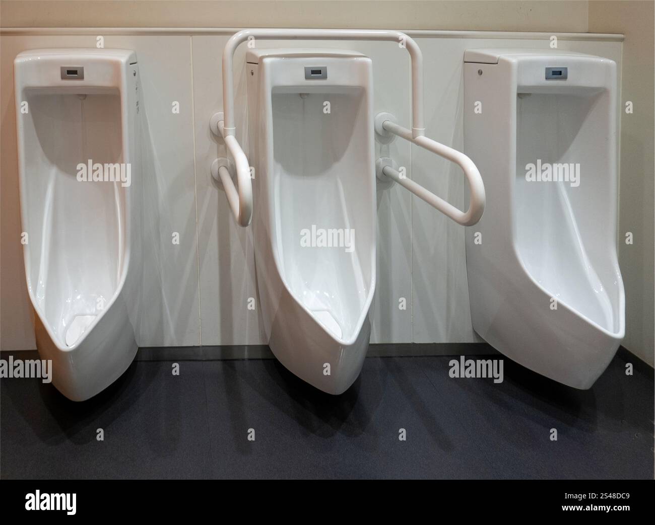 Urinal urinals standing handicap railings railing clean wall floor ...