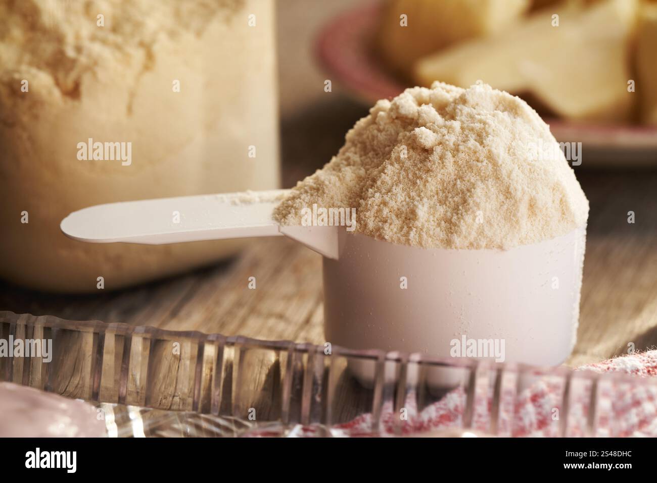 Whey protein powder in a white plastic measuring cup Stock Photo - Alamy
