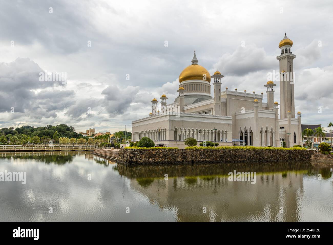 White Omar Ali Saifuddien Mosque golden domes and minarets with lake in ...