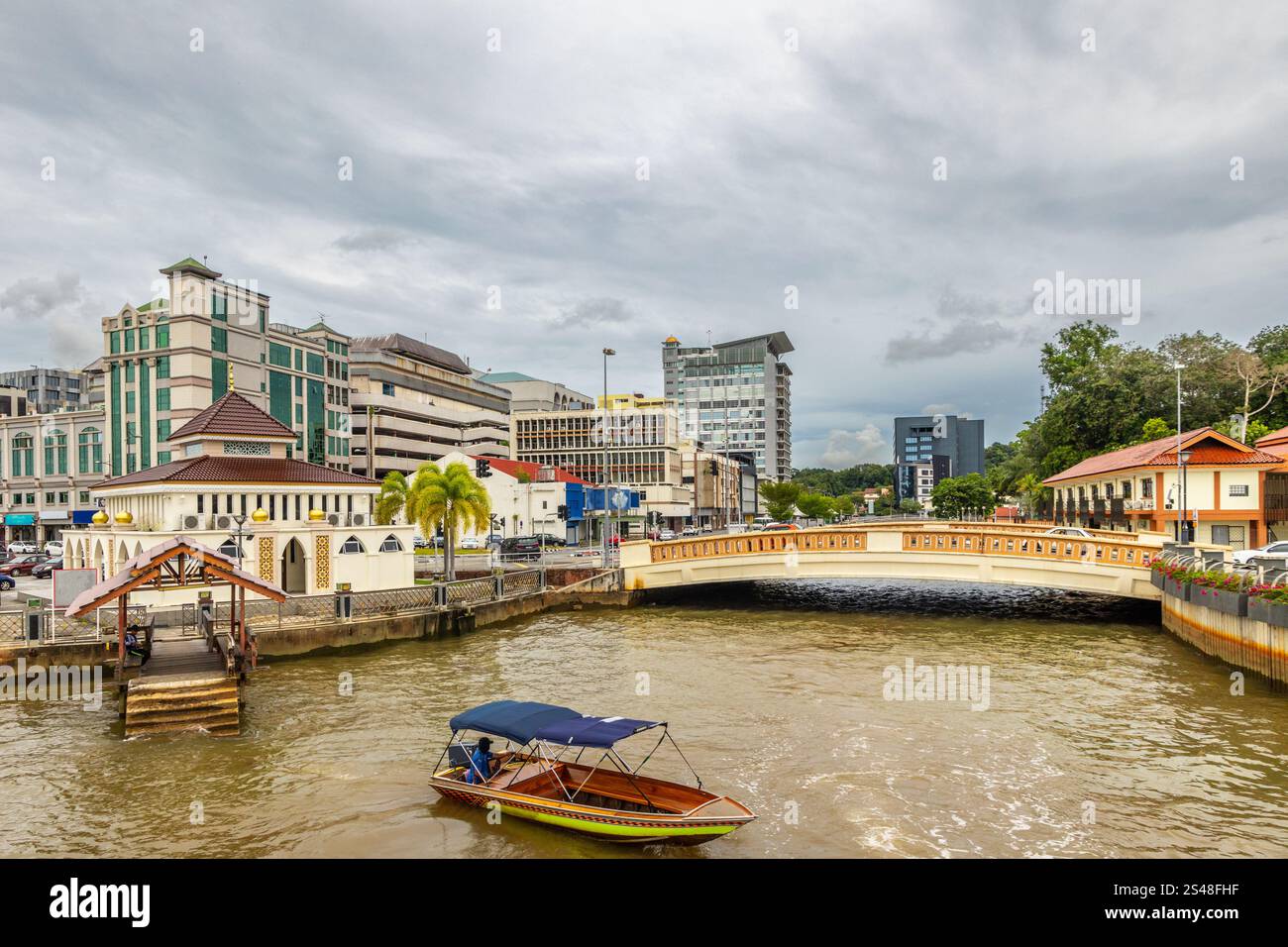 Brunei river with bridge and motor boat and promenade city street with ...