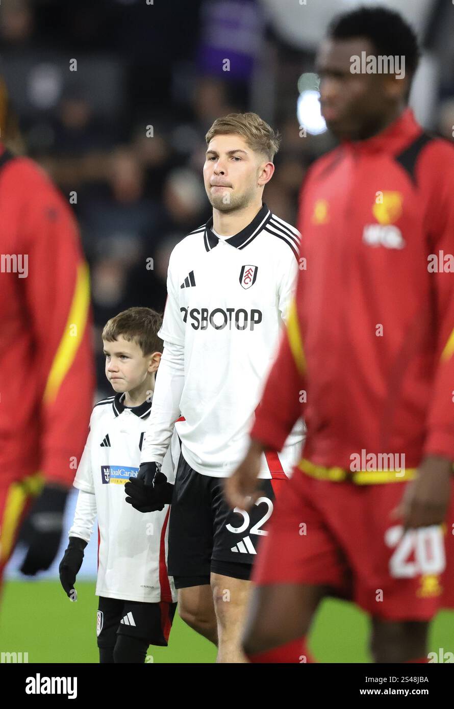 Emile Smith Rowe walking out with his mascot before the Emirates FA Cup ...