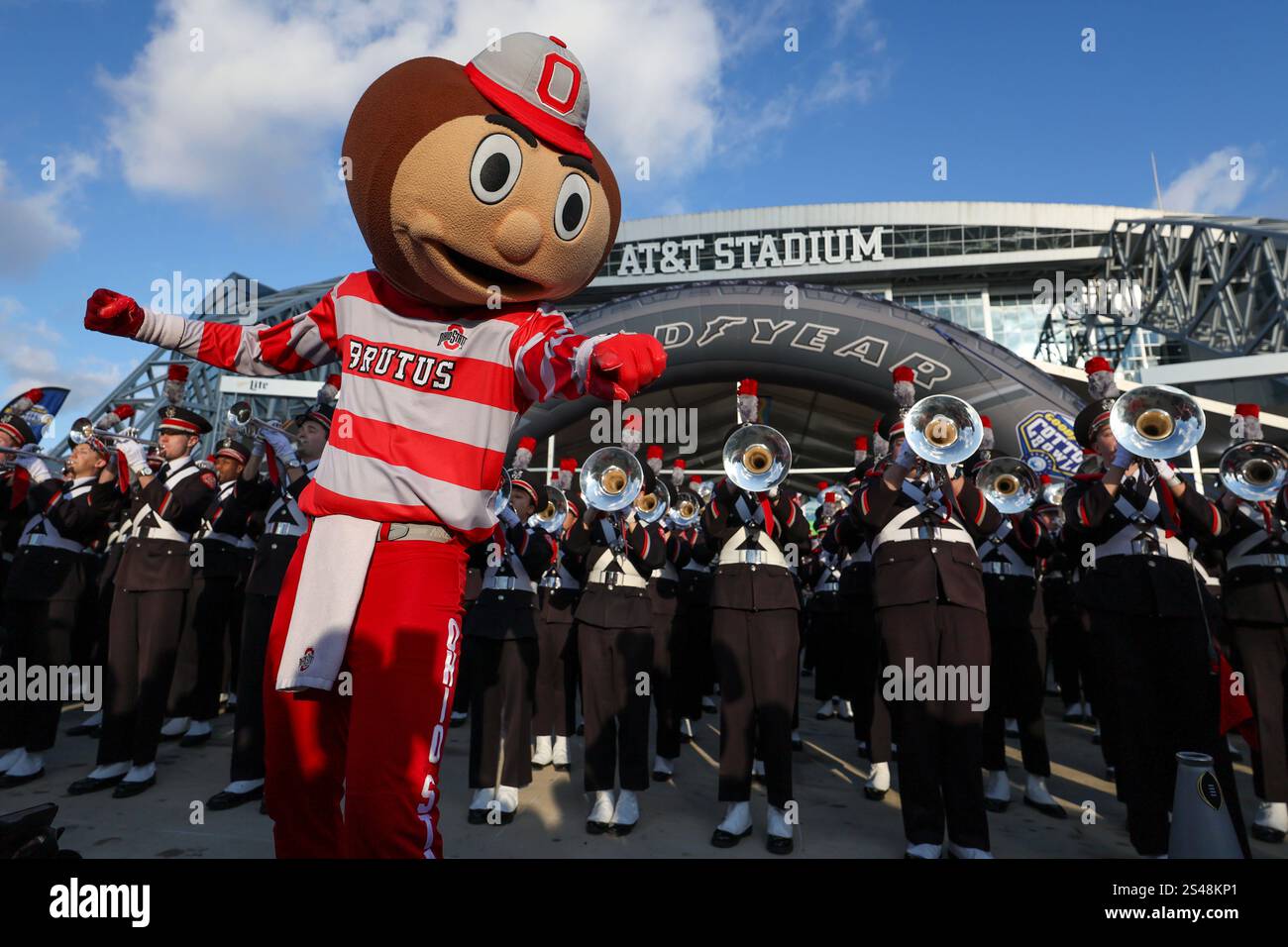 Brutus, the Ohio State mascot, stands with members of the band outside ...