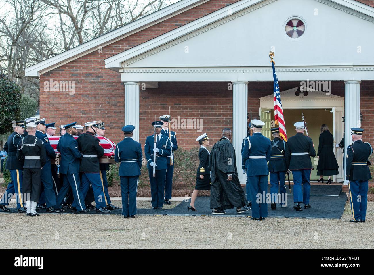 Pastor Tony Lowden walks in front of United States service members ...