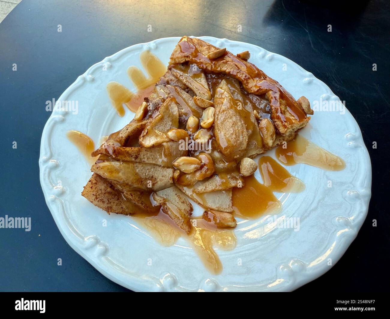 A cut piece of traditional French galette des rois or King cake, with ...