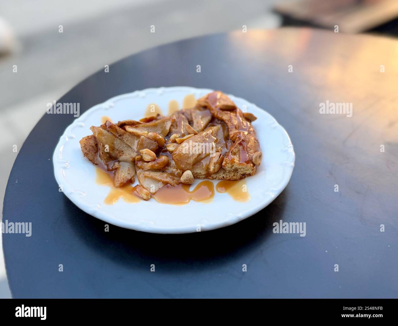 A cut piece of traditional French galette des rois or King cake, with ...