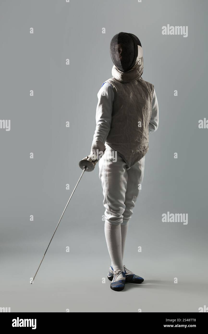 Fencer with epee on gray background. Combat sport Stock Photo - Alamy