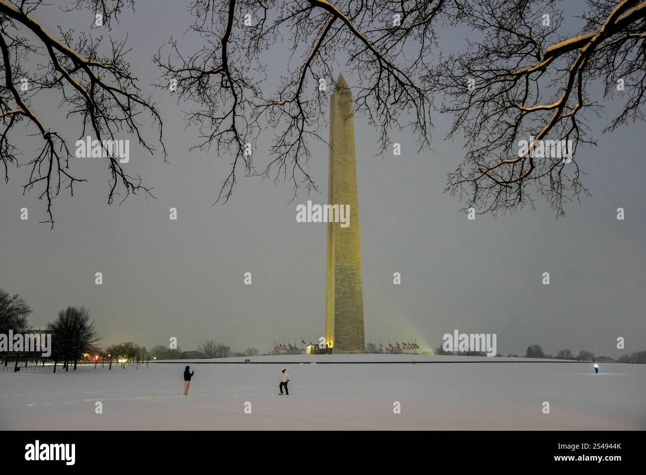 FILE - People walk near the Washington Monument during a winter snow ...