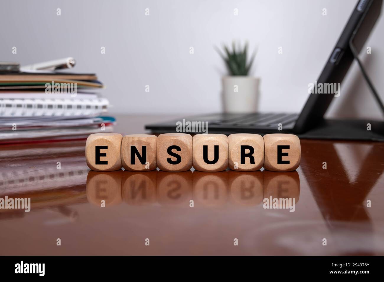 Alphabet letter block in word ensure on wooden background Stock Photo ...