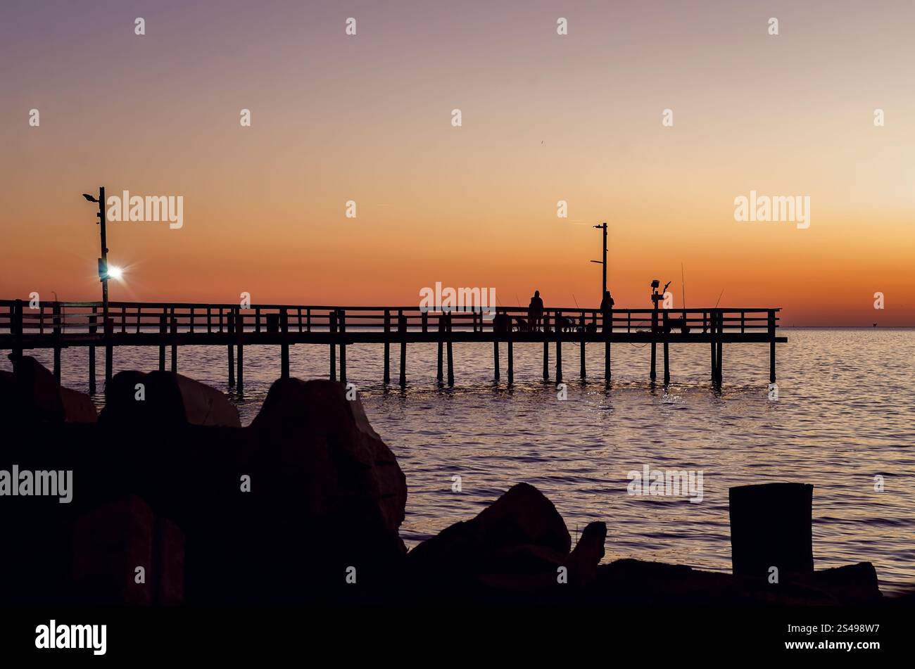 The sun sets at Cedar Point Fishing Pier, January 3, 2025, in Coden ...