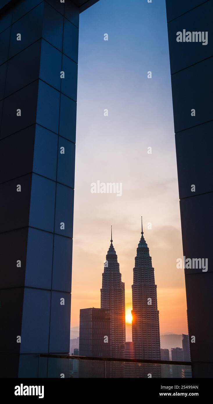 Iconic Towers twins framed by modern architecture during vibrant sunset ...