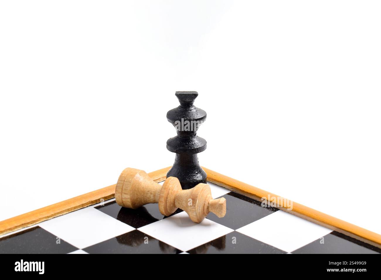 Black chess king defeated white chess king on chess board isolated on ...
