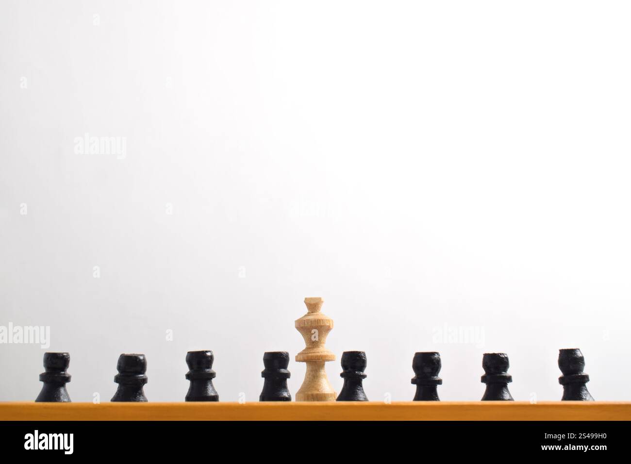 Row of black pawns in front of white king in chess game isolated on ...