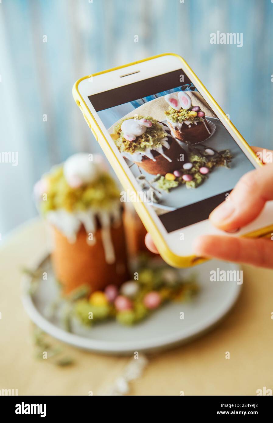 Food bloger making photo using modern smartphone. Paska - the Easter ...