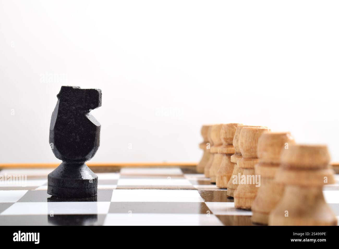 Chess Knight in front of enemy pawns on chess board on white background ...