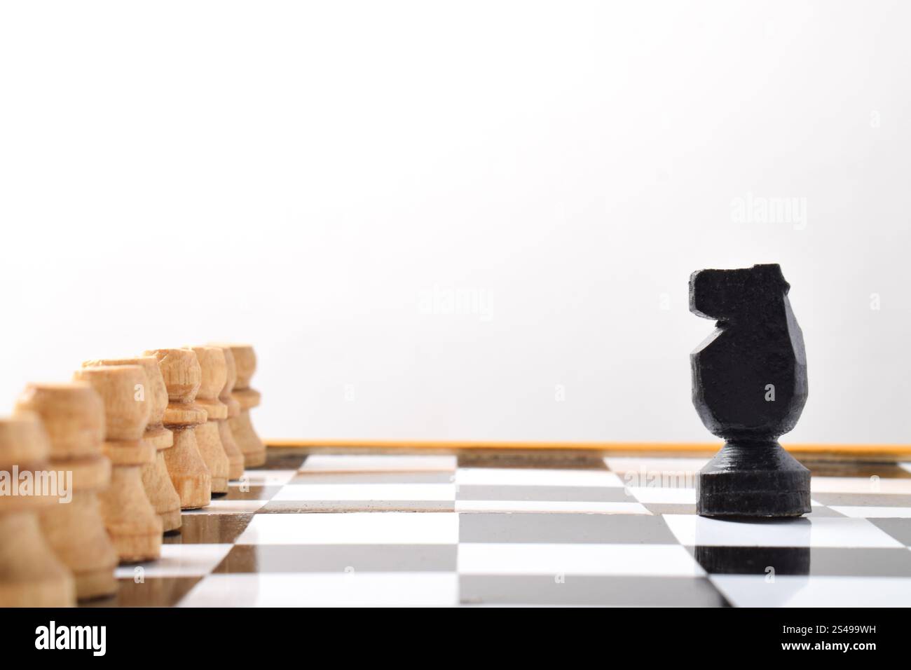 Chess Knight in front of enemy pawns on chess board on white background ...
