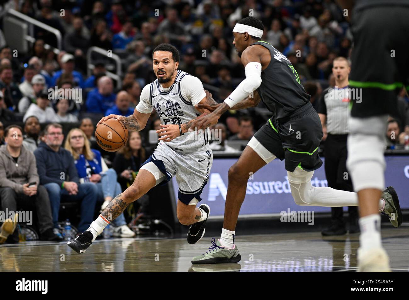 Orlando Magic guard Cole Anthony (50) is defended by Minnesota ...