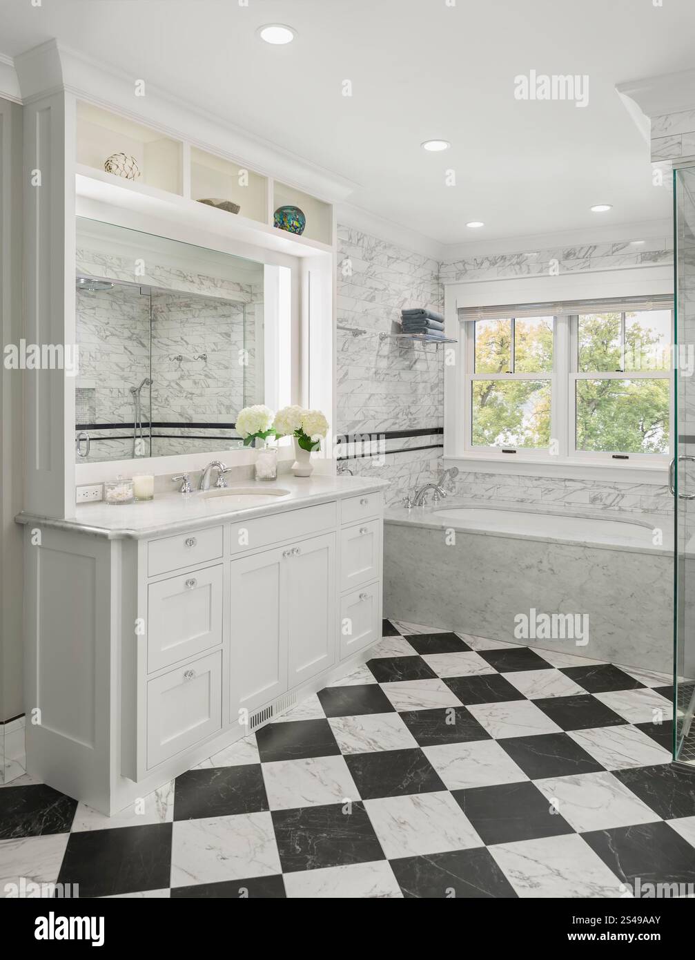 Corner of white bathroom with black and white checkerboard floor and ...
