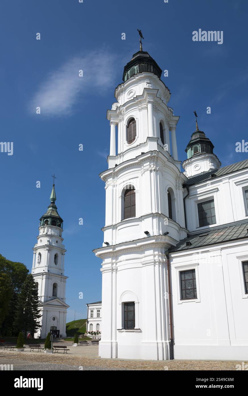 White baroque-style church tower under a clear sky, bell tower and ...