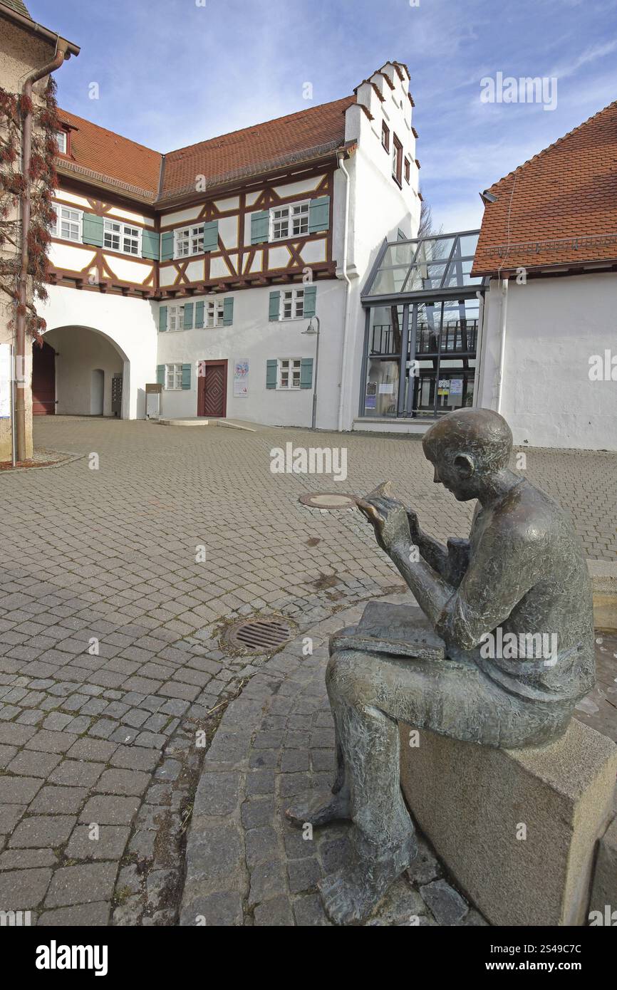 Historical town library with stepped gable and fountain with sculpture ...