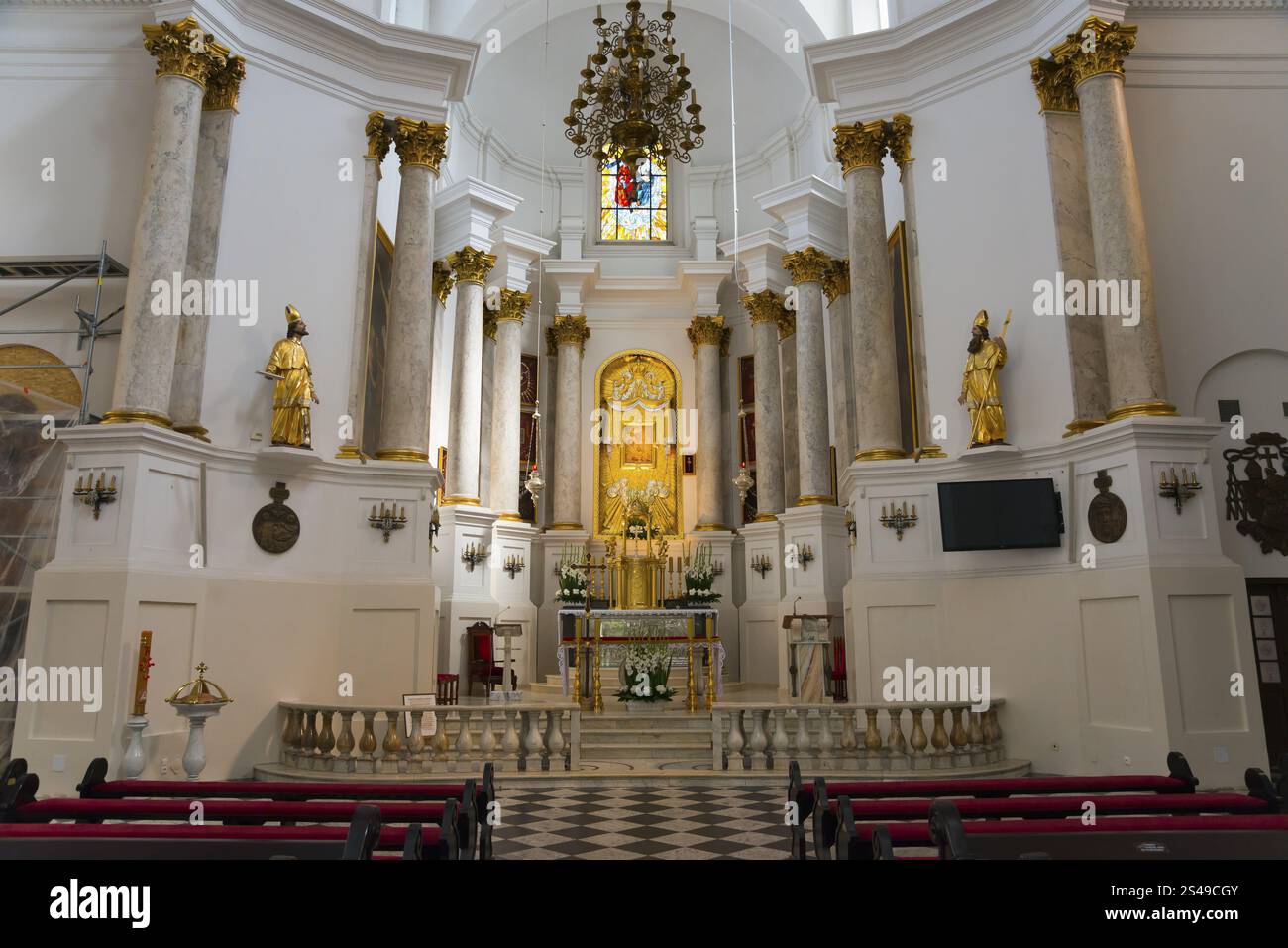 Magnificent Baroque altar area with white columns and golden ...
