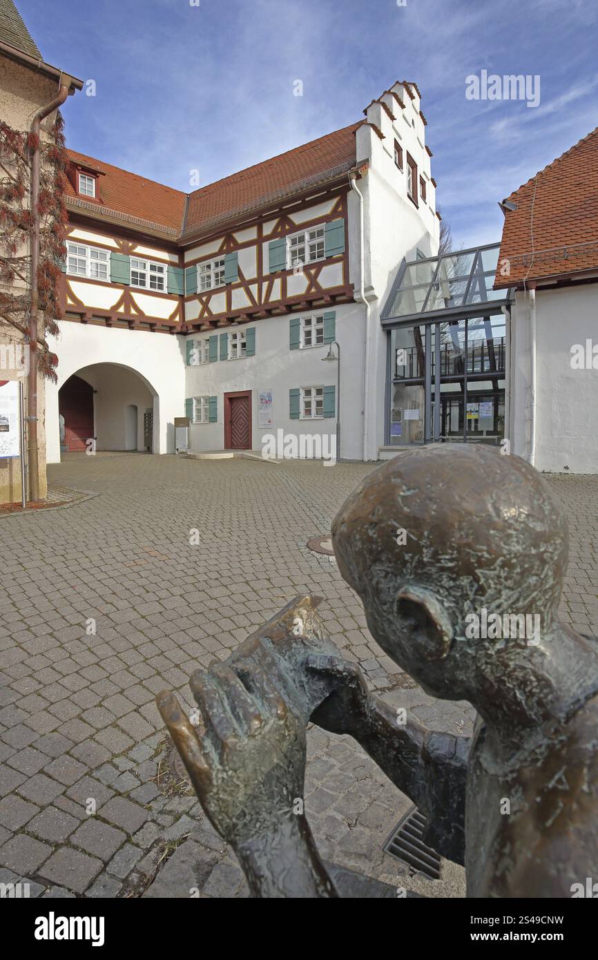 Historical town library with stepped gable and fountain with sculpture ...